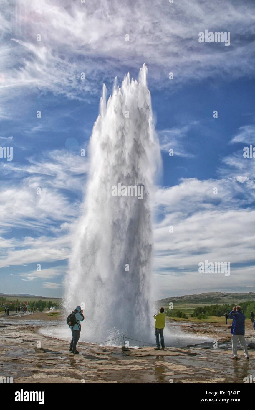 People watching the Strokkur geyser in Iceland explode from the earth ...