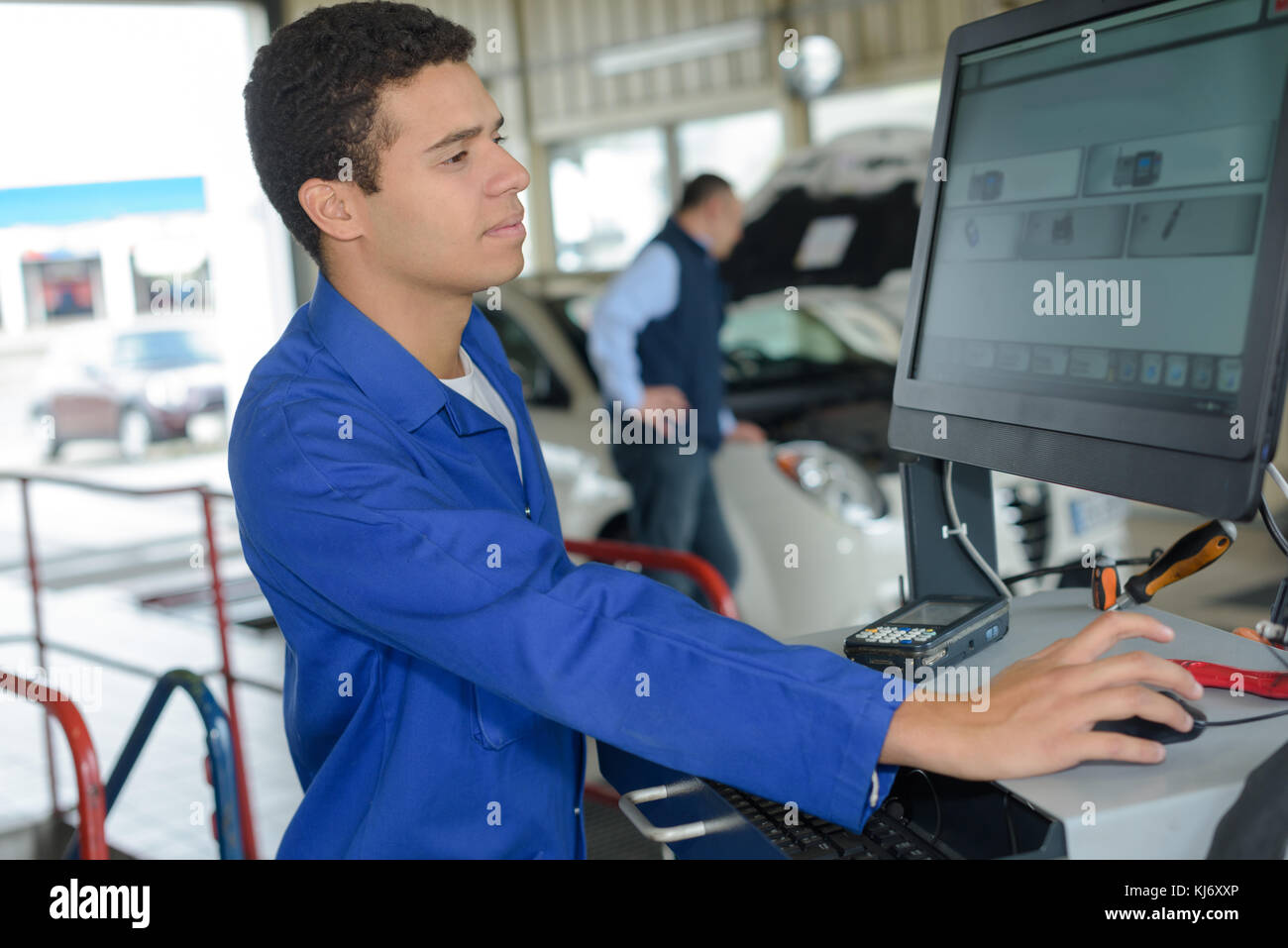 mechanic checking modern electronic diagnostic table Stock Photo - Alamy