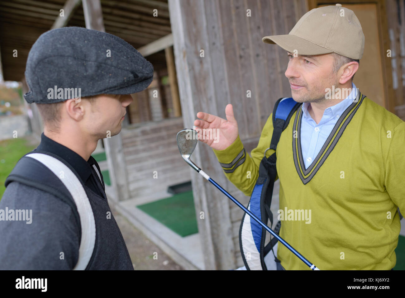 Two golfers talking Stock Photo - Alamy