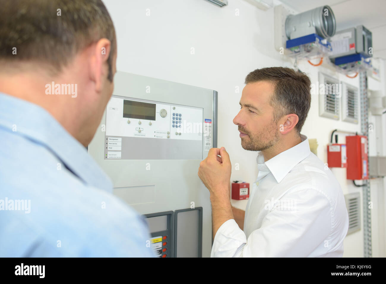 Man looking at electronic display Stock Photo - Alamy
