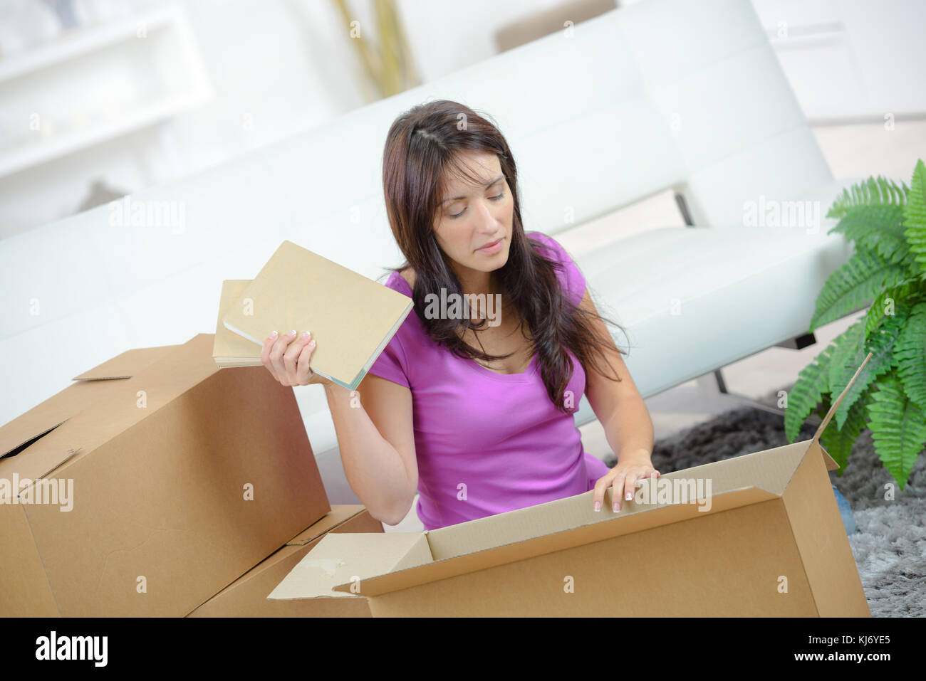 happy young woman opening a carton box Stock Photo - Alamy