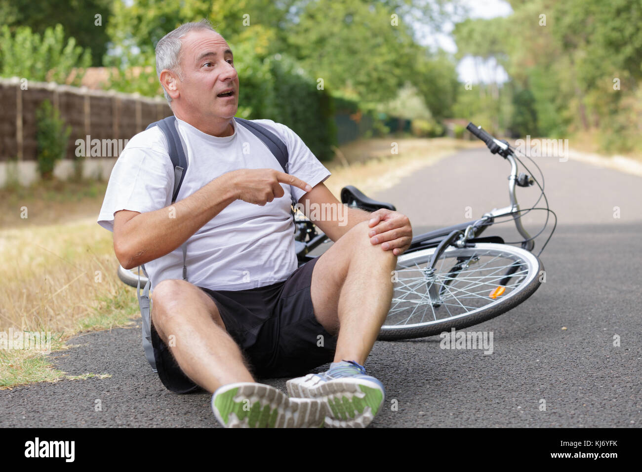 aching man after bicycle accident on the asphalt Stock Photo - Alamy