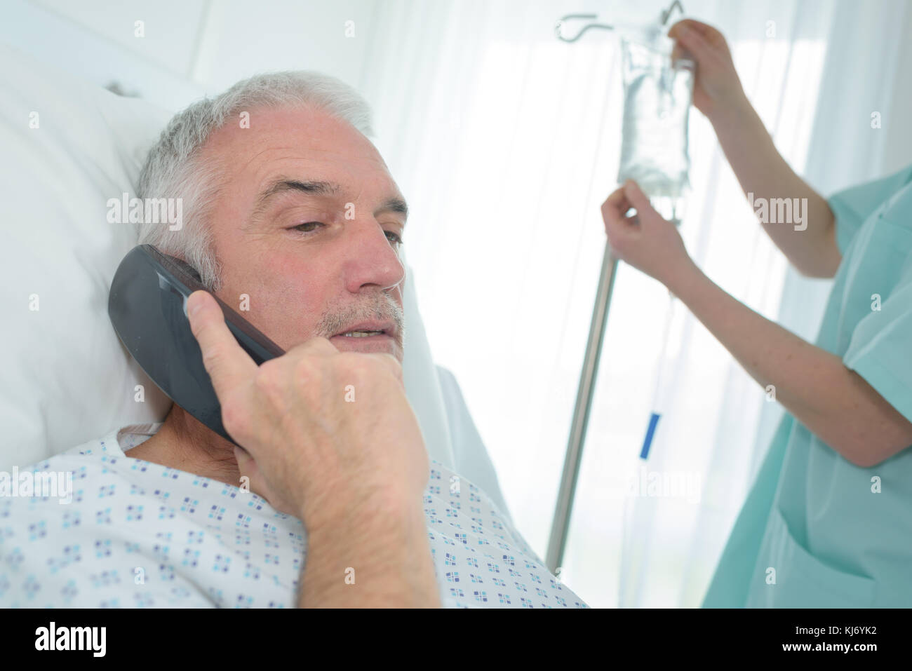 senior patient in hospital using phone Stock Photo - Alamy