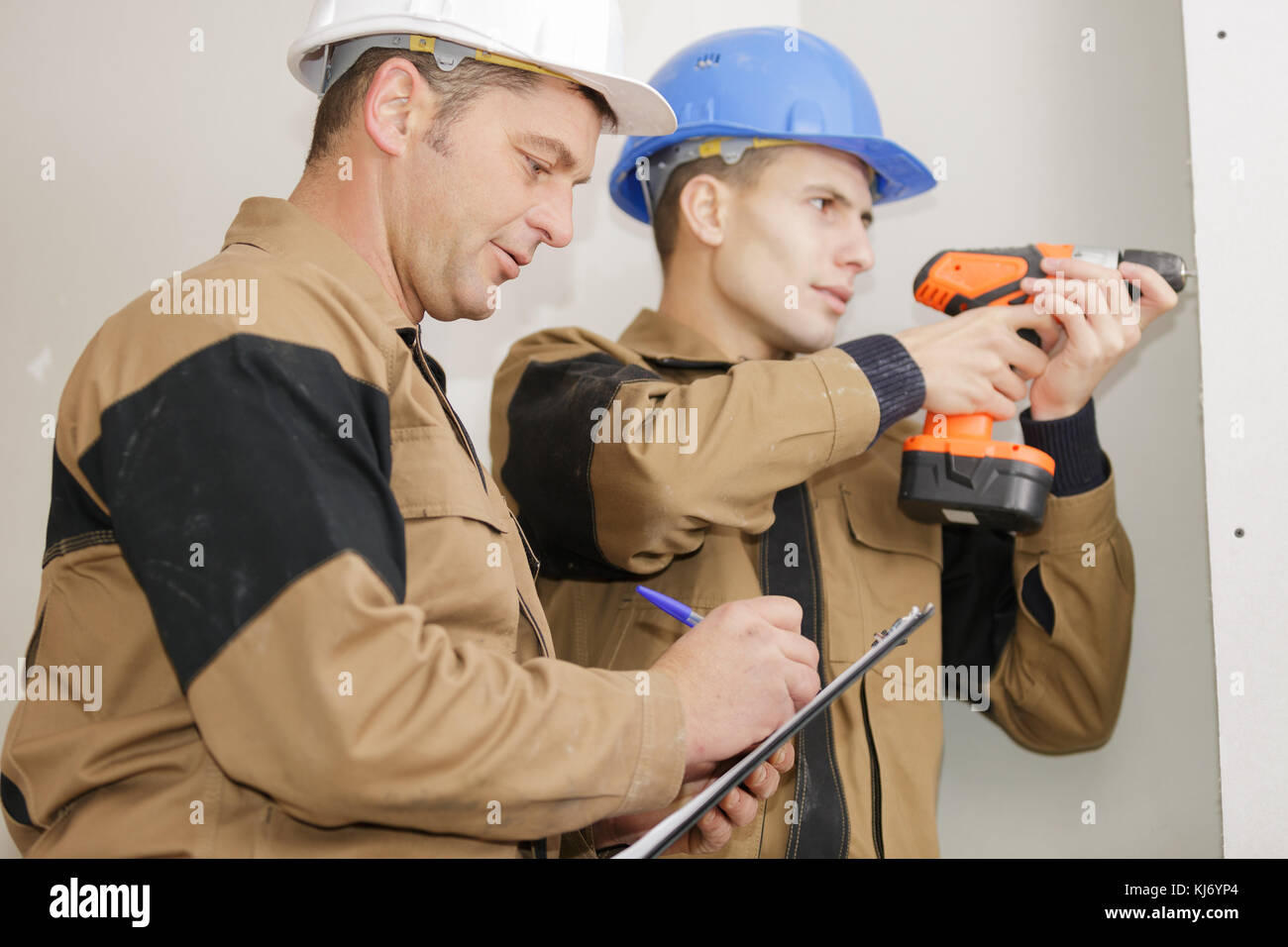 construction site workers drilling with a machine or drill Stock Photo ...