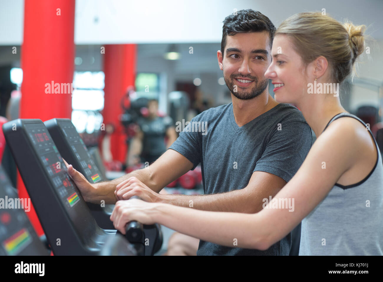 woman doing cardio workout on treadmill with personal trainer Stock ...