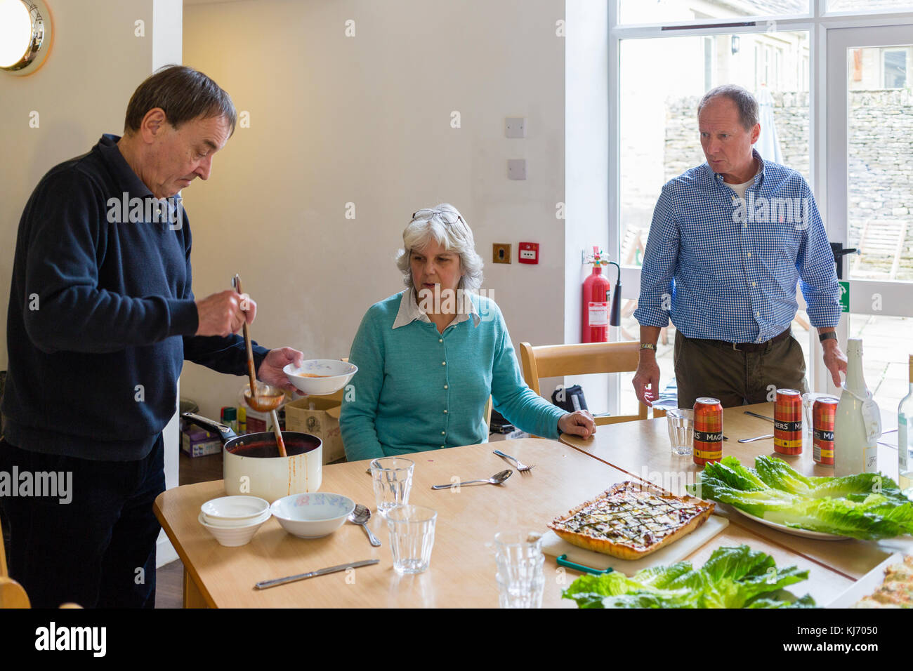 Older people eating together in communal kitchen, England, UK Stock ...