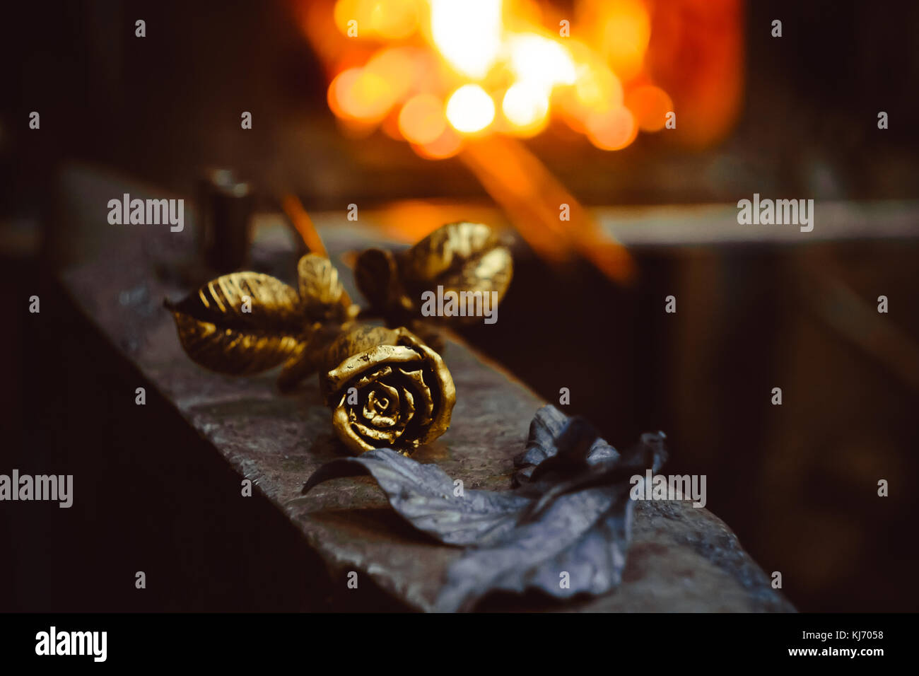 A metal forged rose lies on the pier in the smithy Stock Photo - Alamy