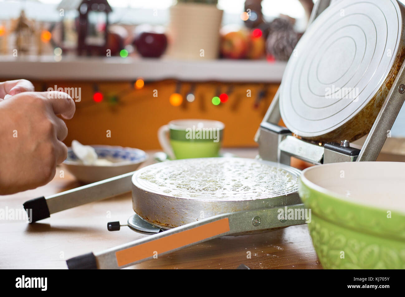 Sizzling butter on top of the wafer making machine. Traditional ...