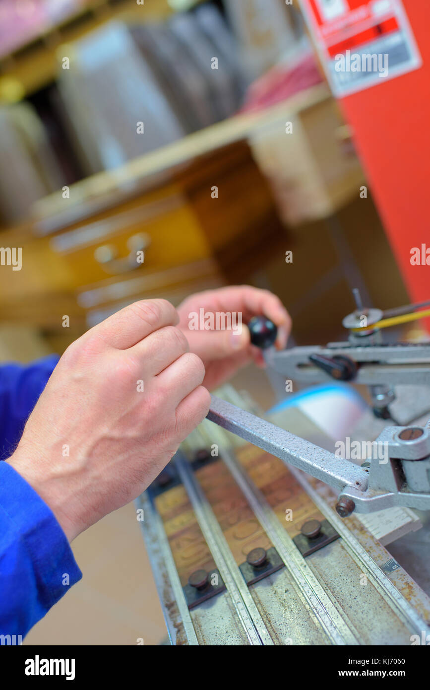 Workman setting up machine Stock Photo - Alamy