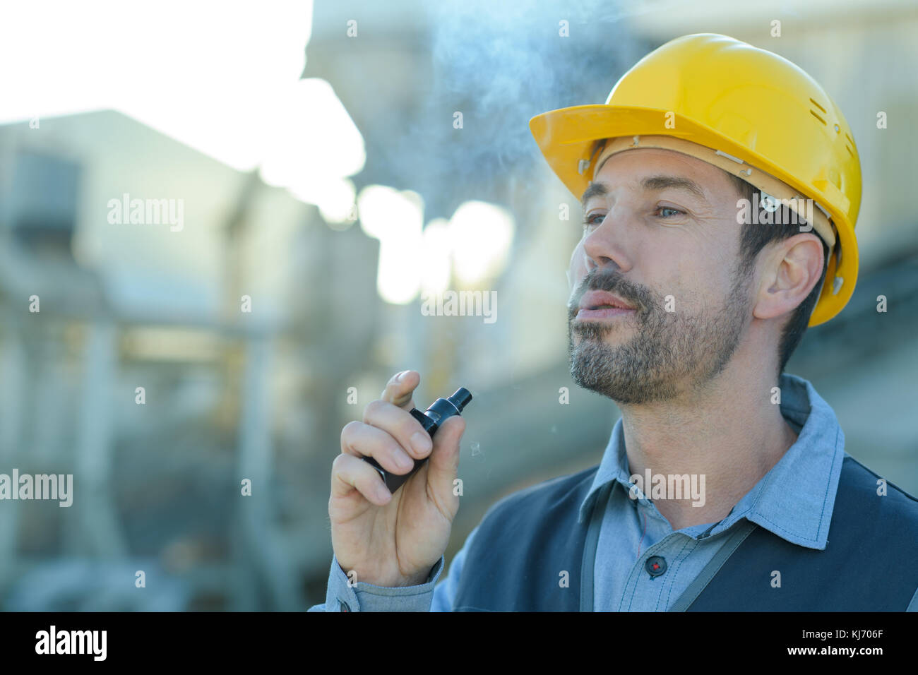 construction worker vaping on site Stock Photo - Alamy