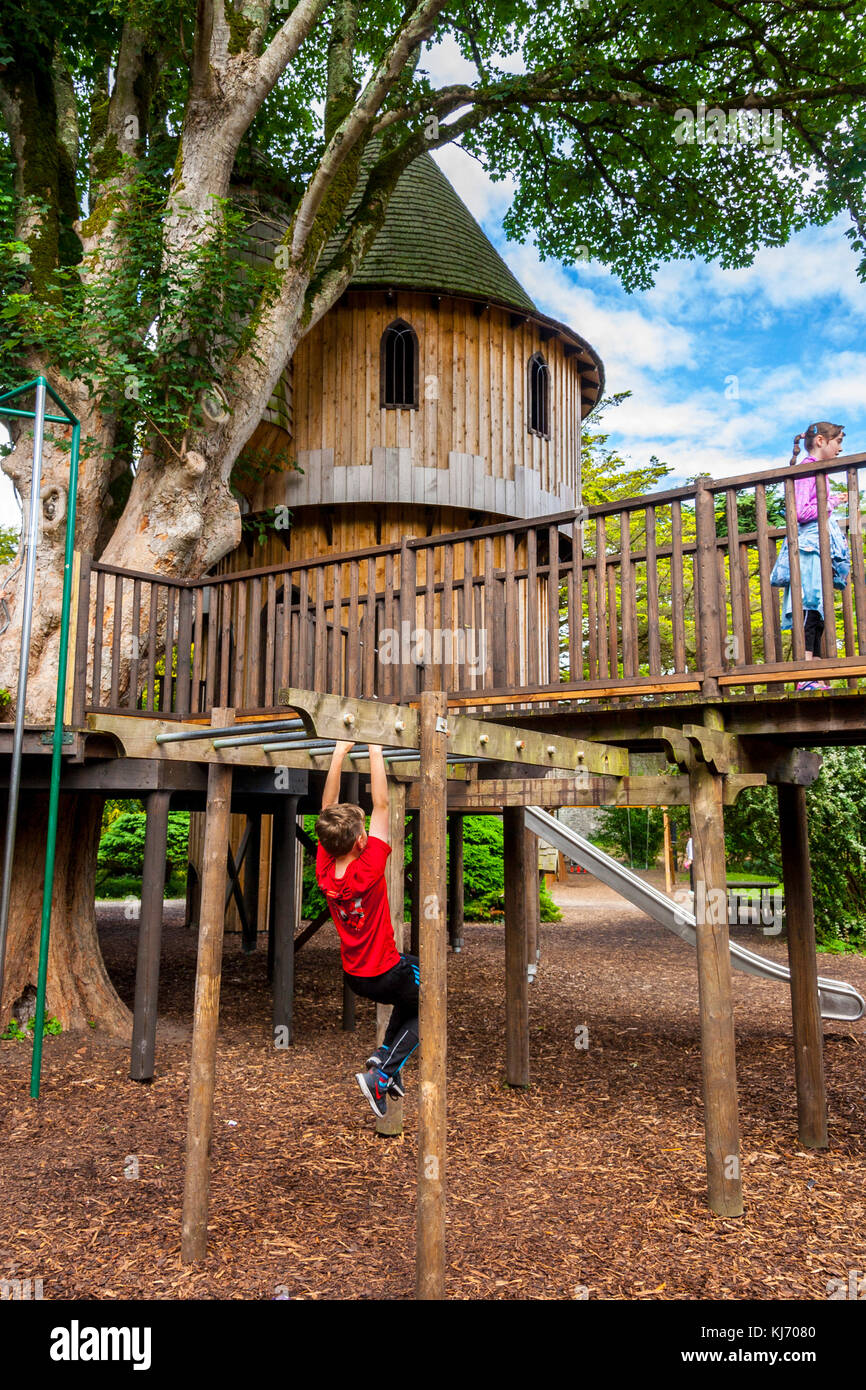 Children, kids playing and climbing in a playground in summer Ireland ...