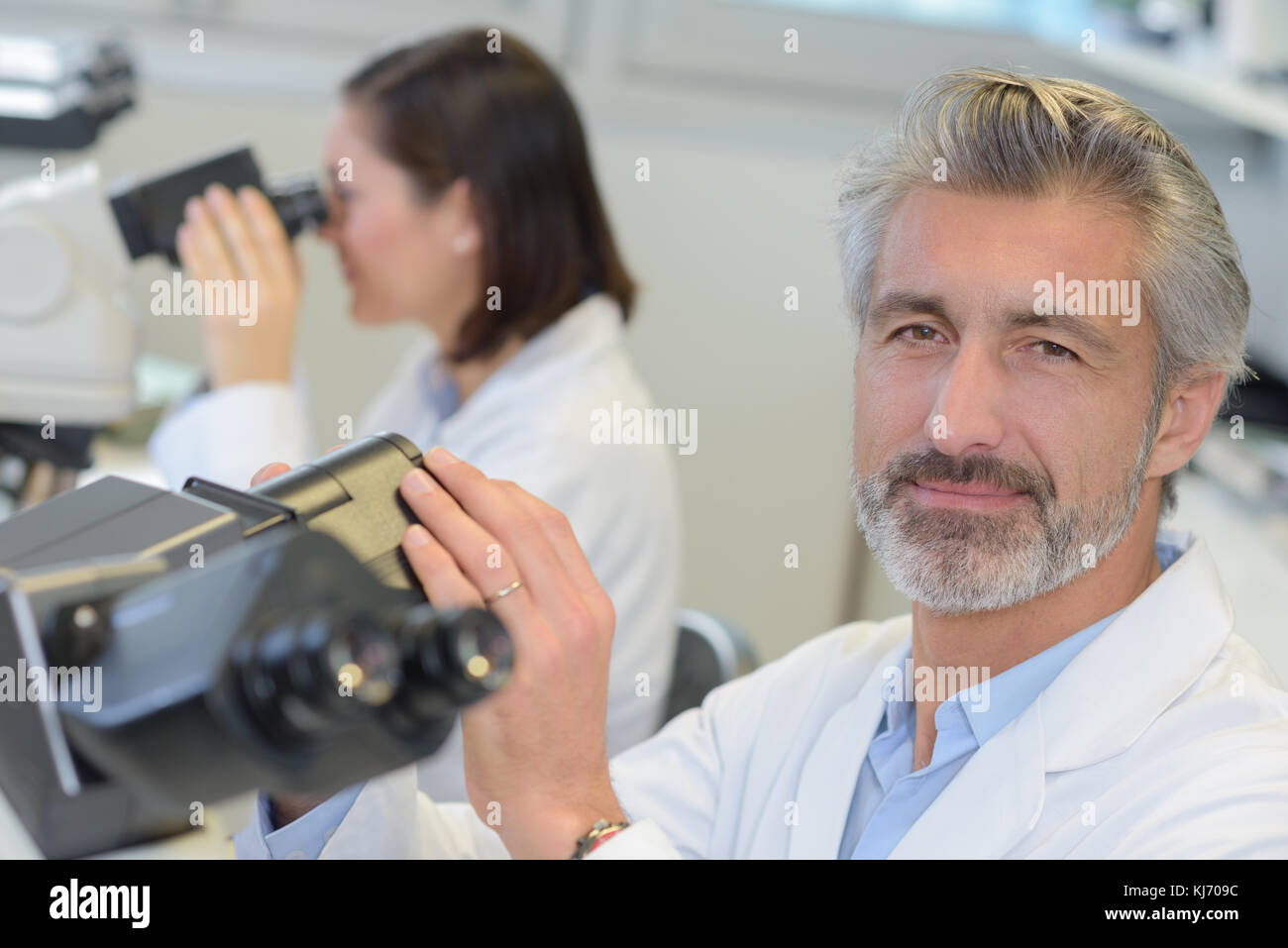 mature male researcher using microscope in medical laboratory Stock ...