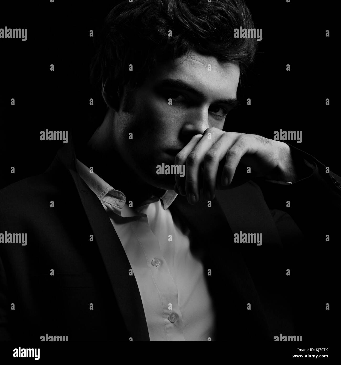 Thinking charismatic man posing and looking with hand near the face on ...