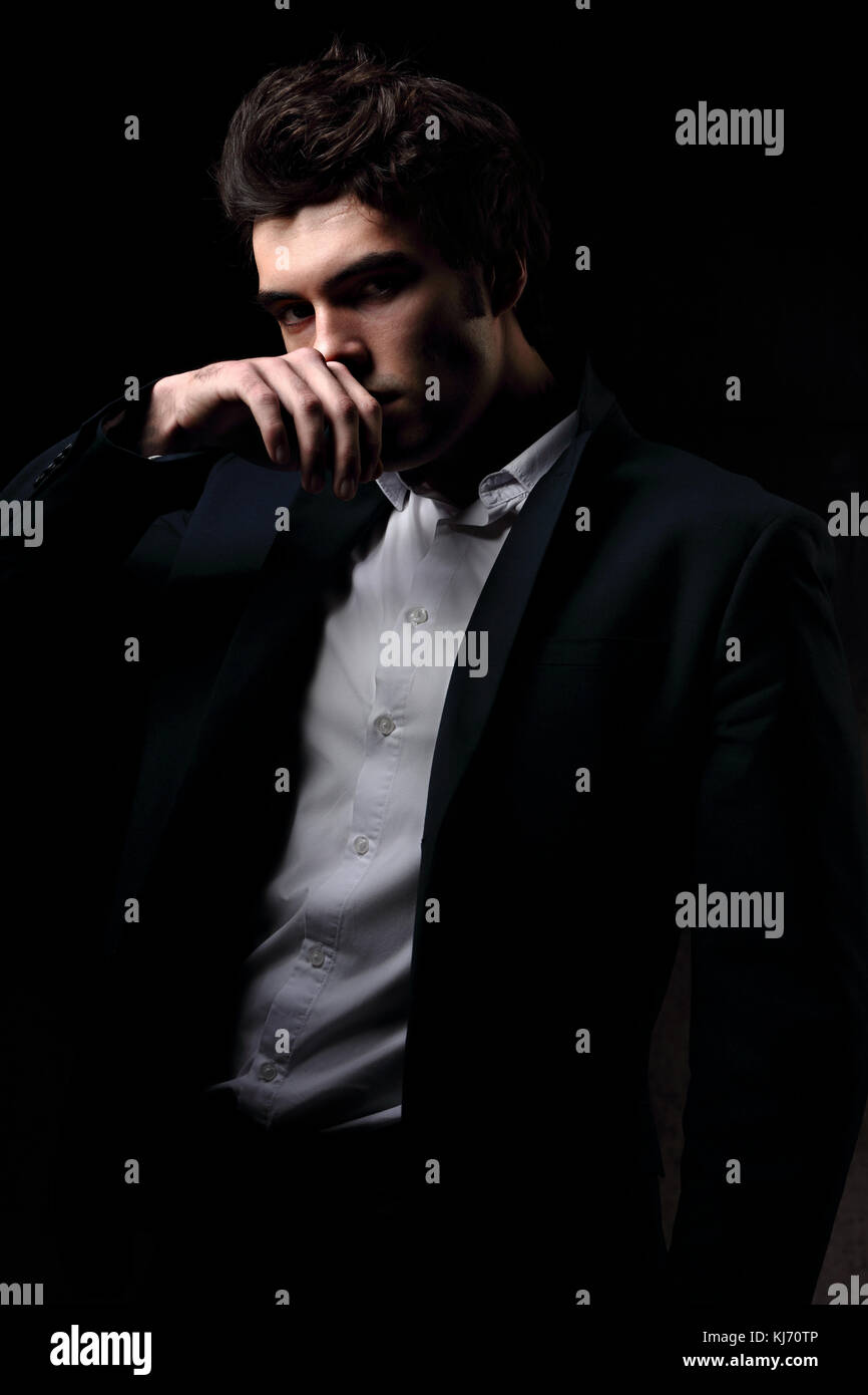 Thinking charismatic man posing and looking with hand near the face on ...