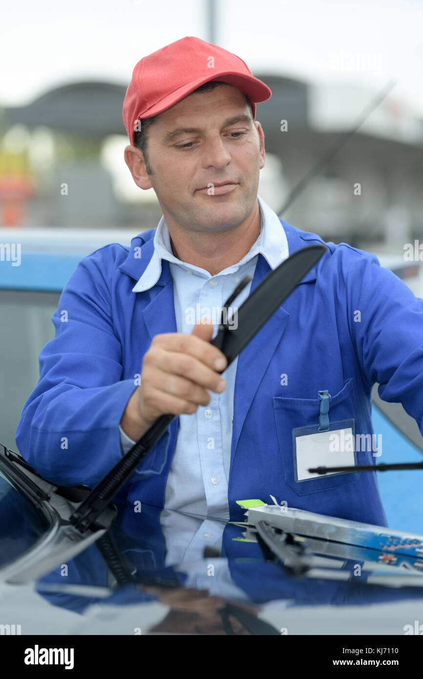 automotive technician replacing a windshield wiper Stock Photo - Alamy