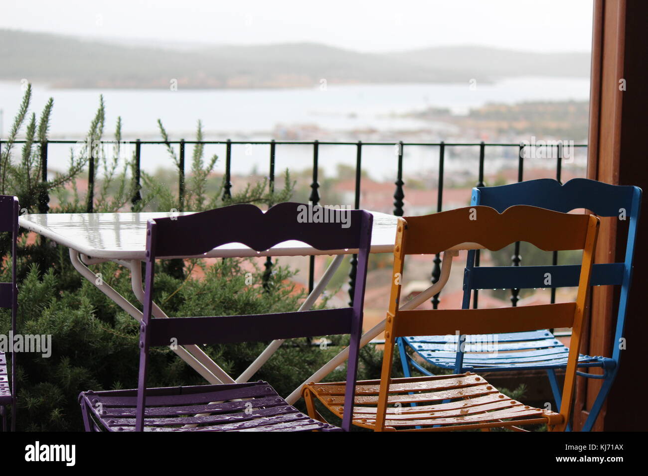 Colored chairs with a view Stock Photo - Alamy