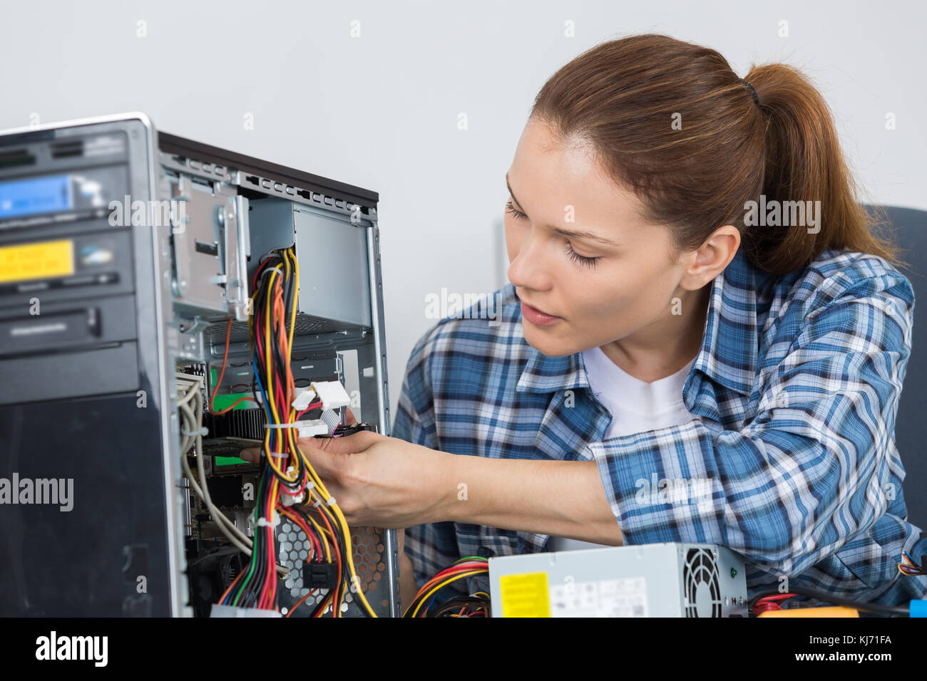 Woman repairing tower computer Stock Photo - Alamy
