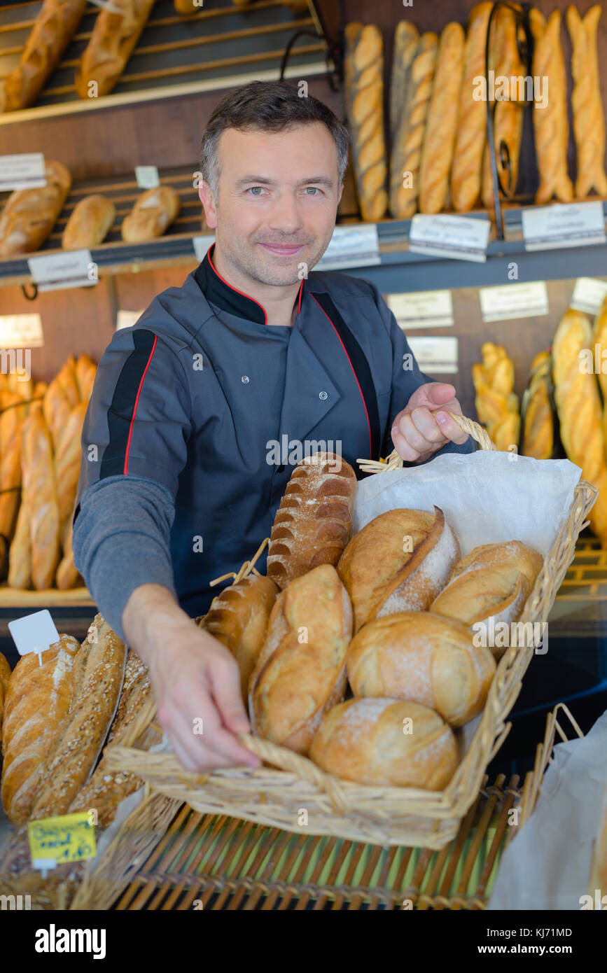bakery shopkeeper is proud of his bread production Stock Photo - Alamy