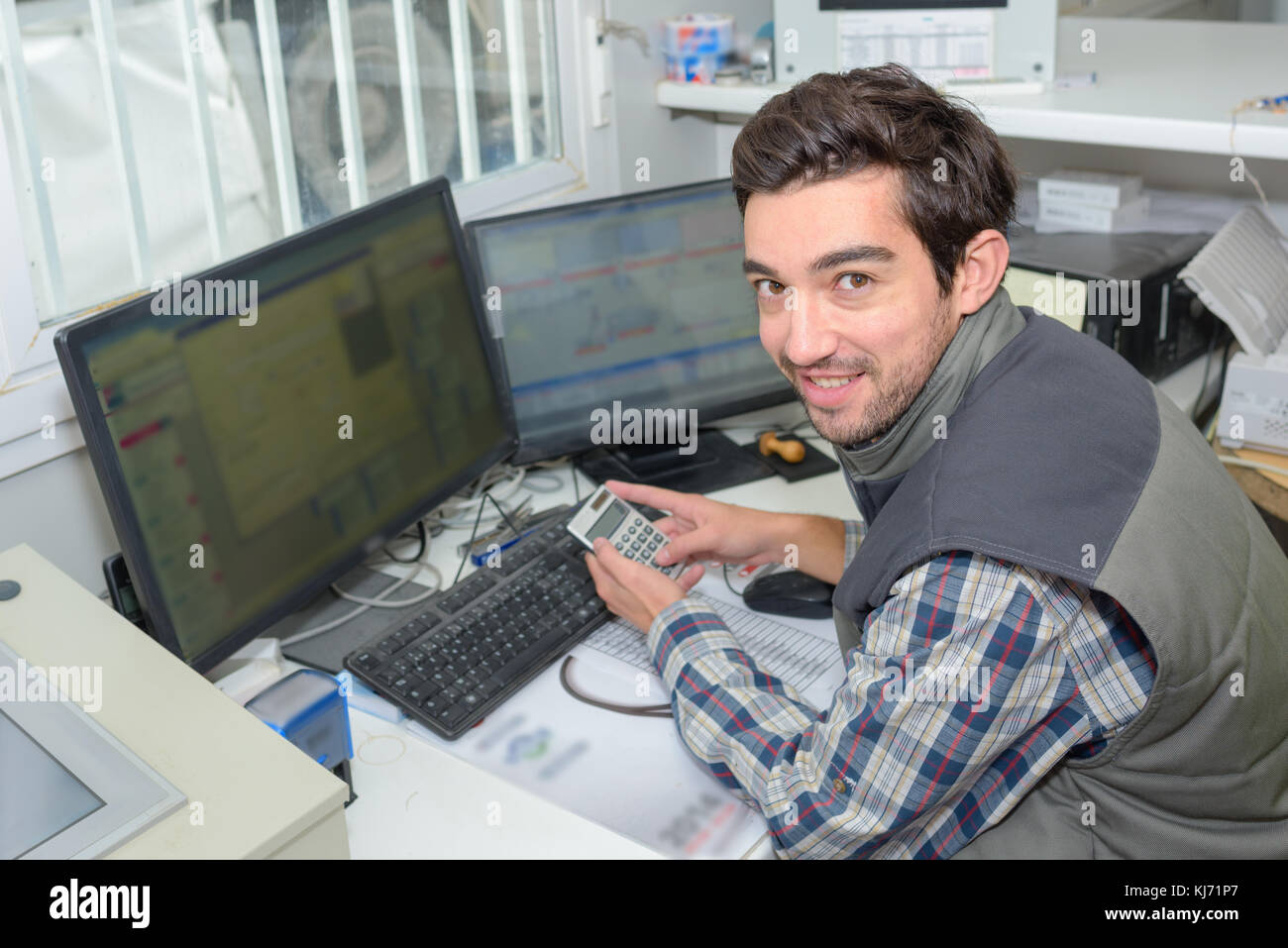 Man using calculator in work office Stock Photo - Alamy