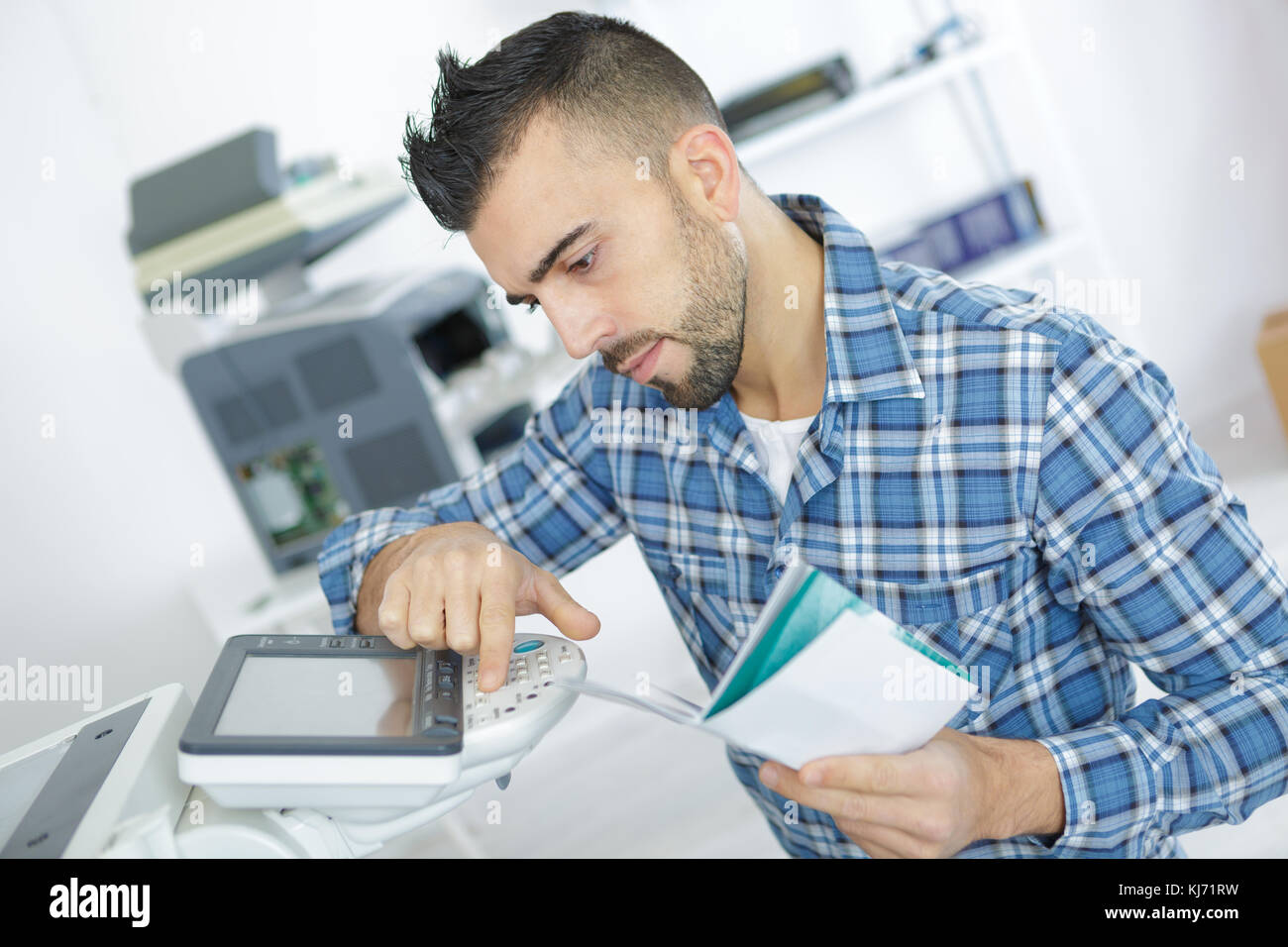 young attractive worker man working using printmaking device Stock ...
