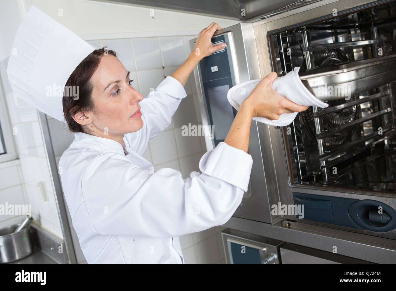 beautiful female chef working with oven Stock Photo - Alamy