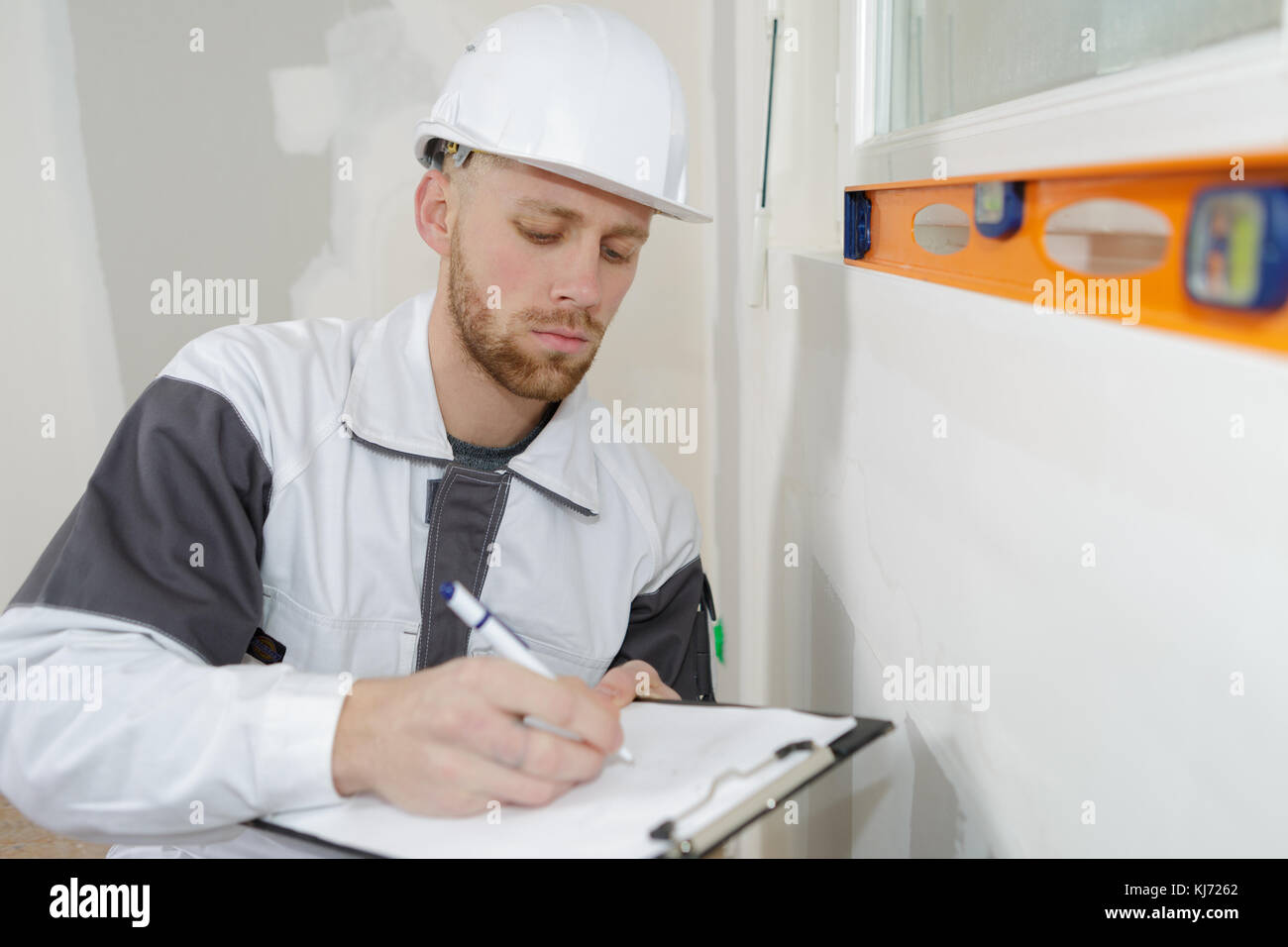 builder writing down construction results Stock Photo - Alamy