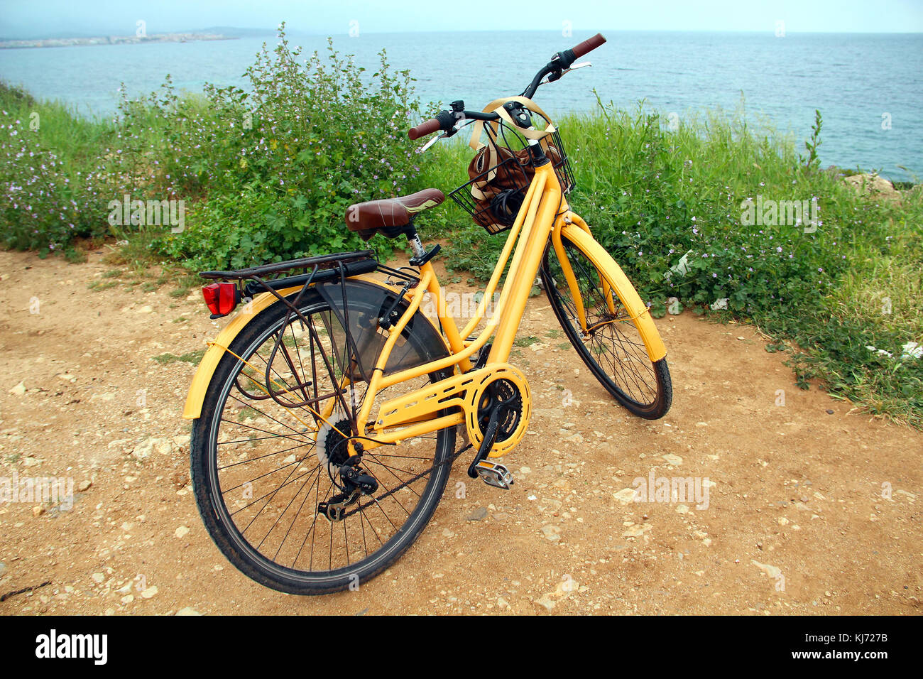 Old yellow bike at the seaside on Sardinia, Italy Stock Photo - Alamy