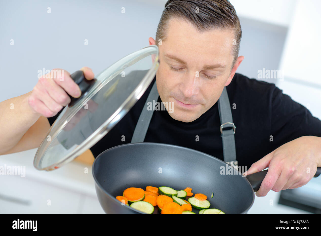 man cooking at home and preparing food Stock Photo - Alamy