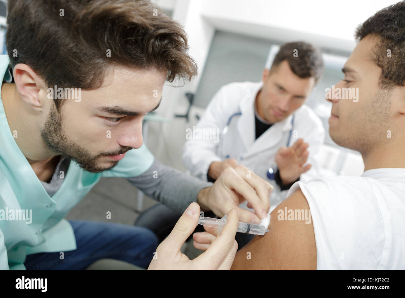 male nurse doing injured man tetanus toxoid injection Stock Photo - Alamy