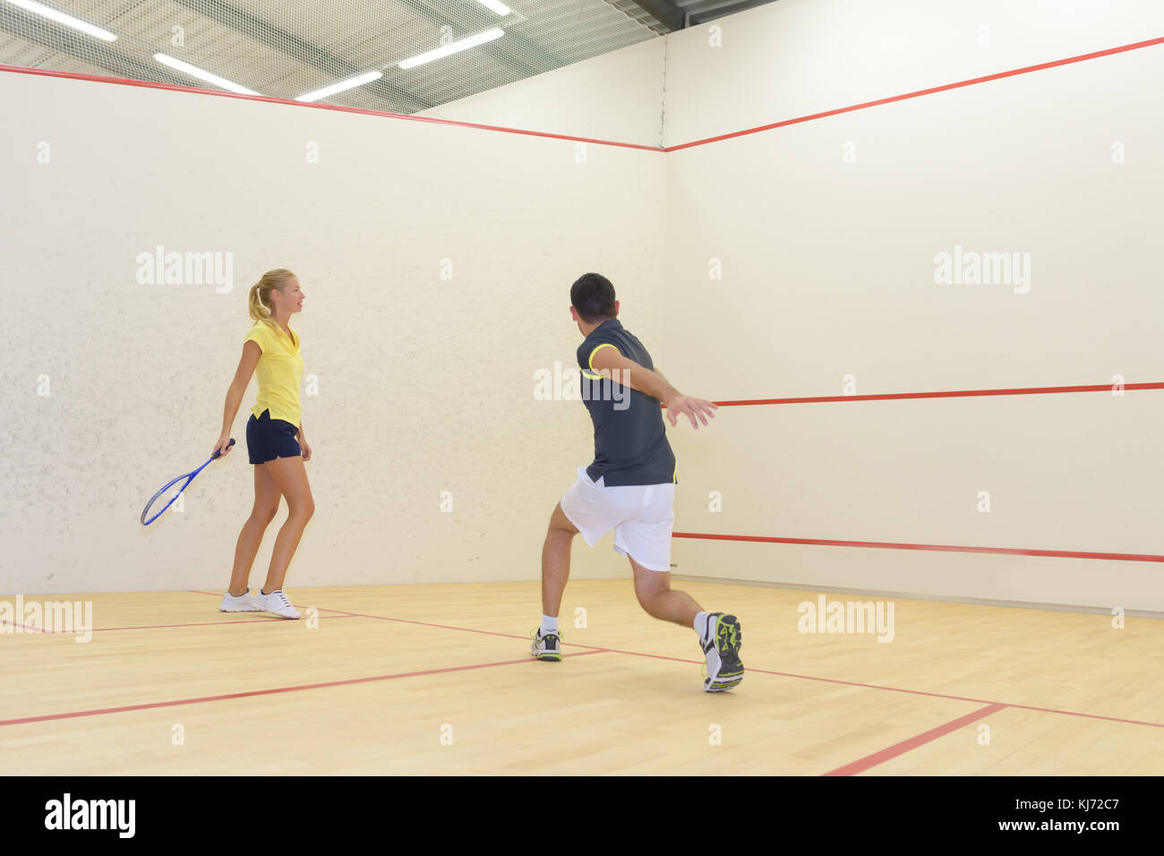 couple play some squash together in the squash court Stock Photo - Alamy