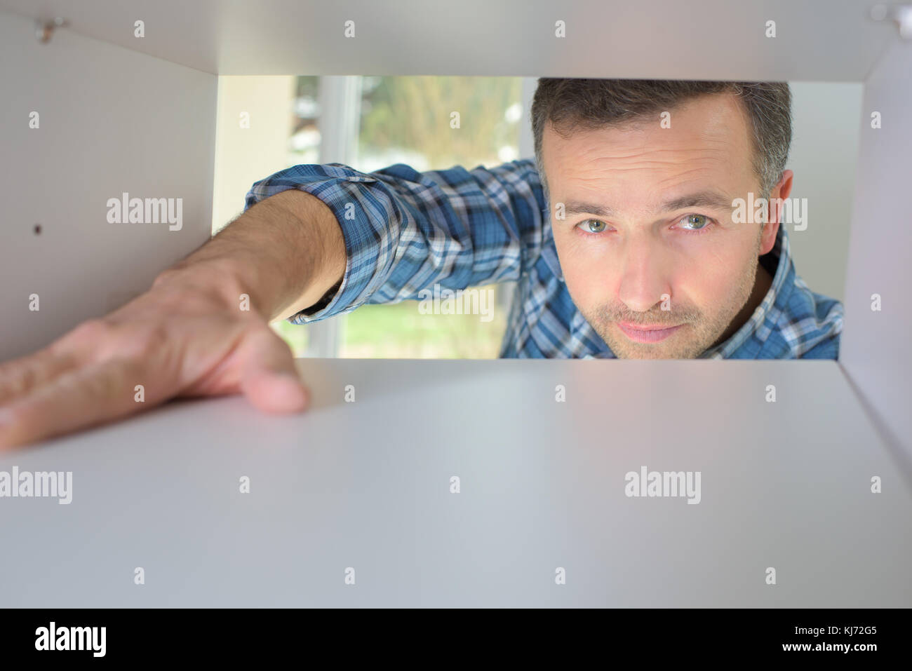 happy man looking inside box Stock Photo - Alamy