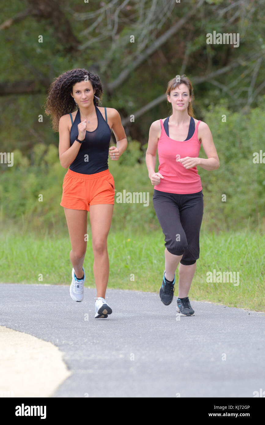 Two women jogging Stock Photo - Alamy