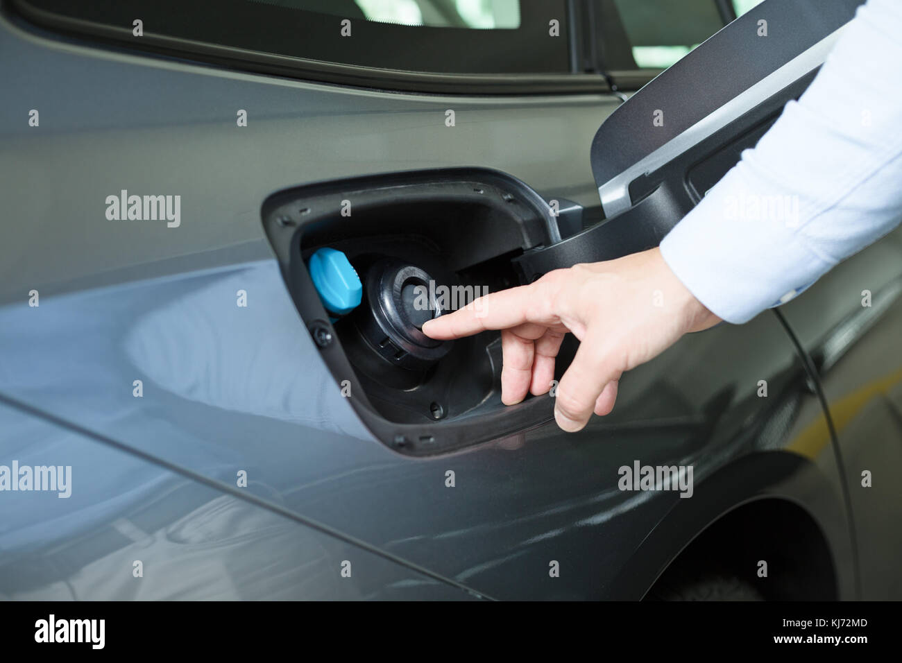 Close up of male hand pointing to the car fill spout Stock Photo - Alamy