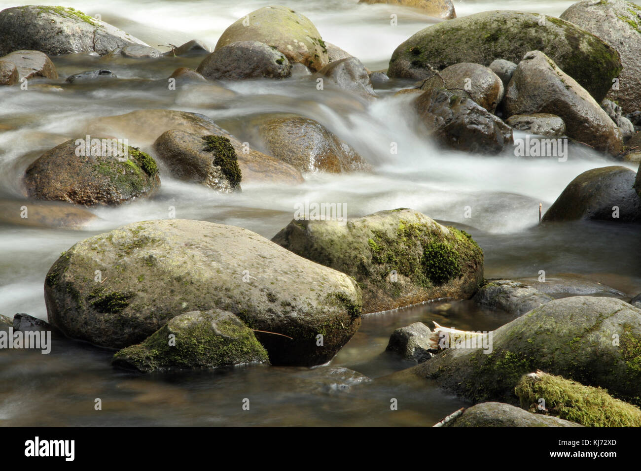 Close up picture of rocks in a river with the water streaming by Stock ...