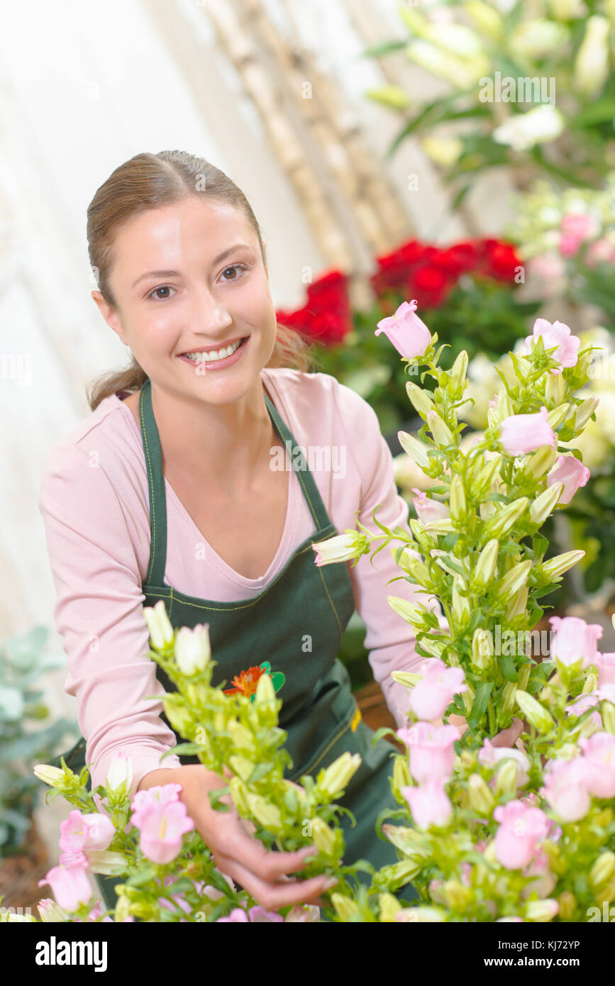 Smiling florist sorting flowers Stock Photo - Alamy