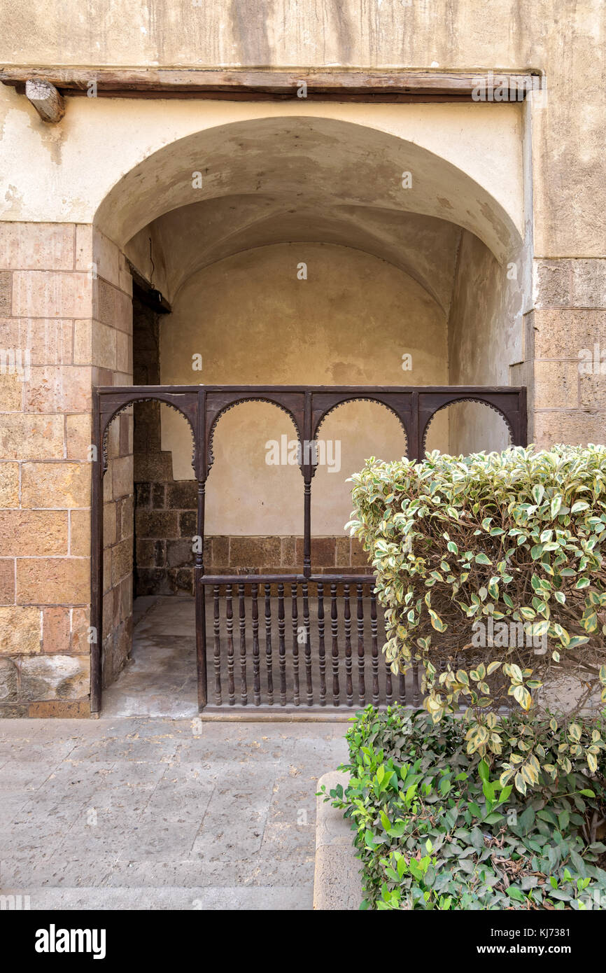 Embedded space with wooden balustrade and wooden arches behind a ...