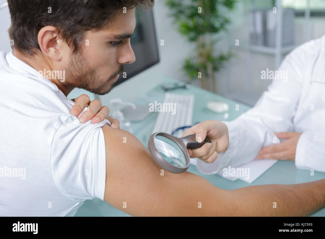 close-up of doctors hands checking mans moles Stock Photo - Alamy