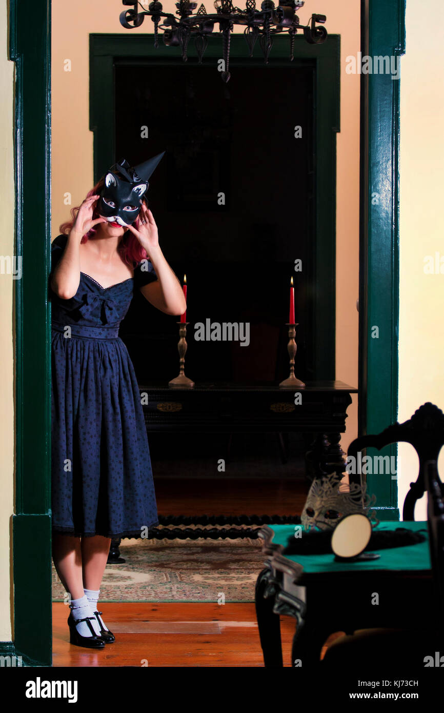 Halloween theme vintage girl wearing a cat mask Stock Photo - Alamy