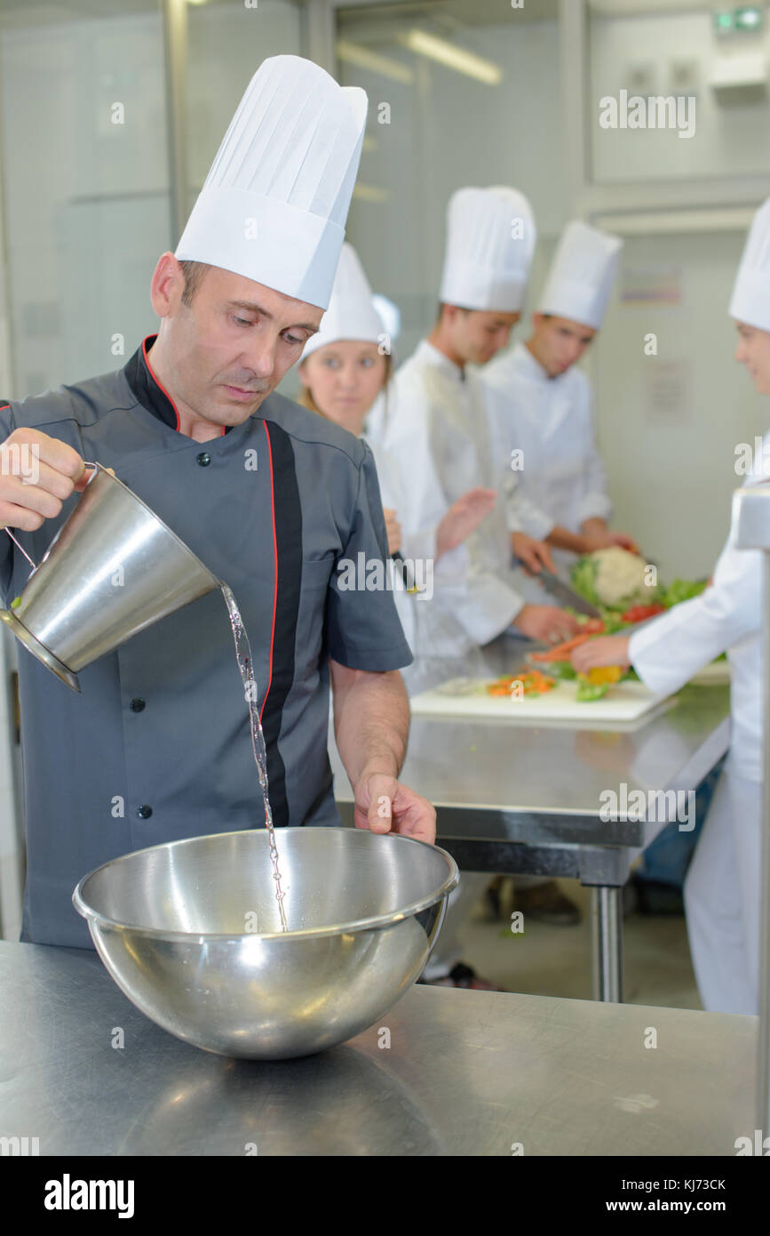 Chef pouring water into bowl Stock Photo - Alamy
