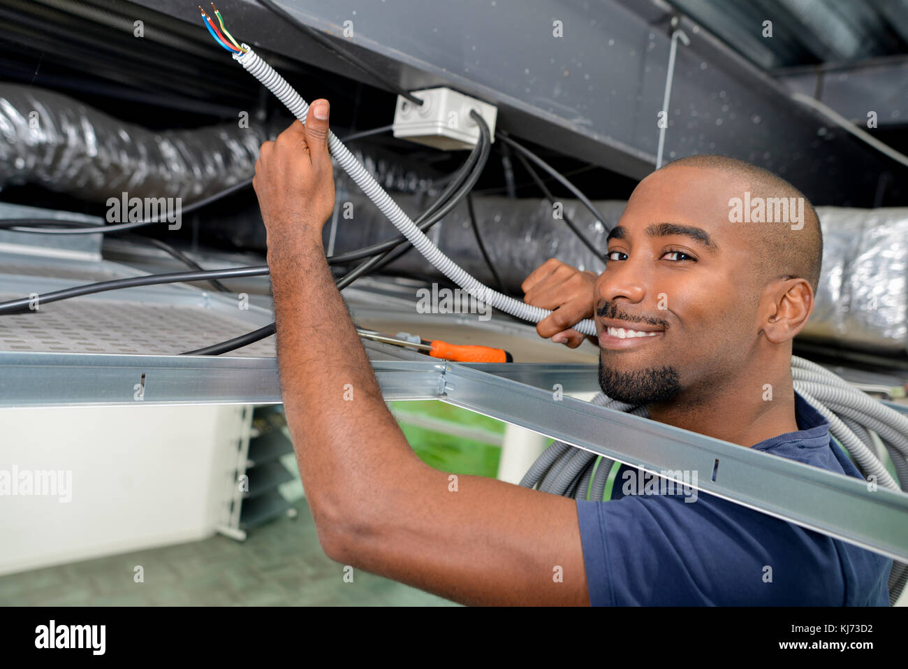Fixing ceiling wiring Stock Photo - Alamy
