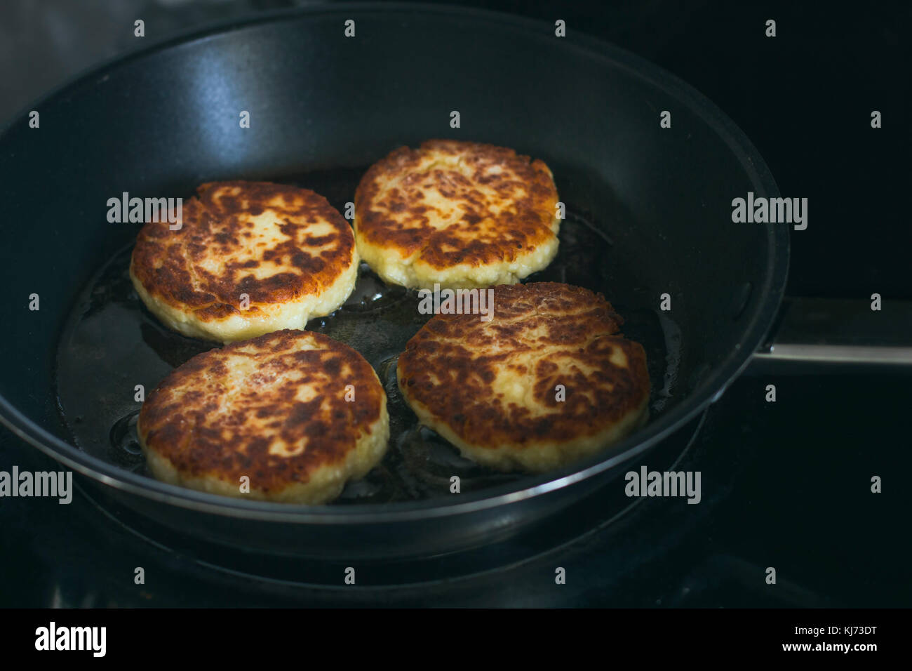 The cottage cheese pancakes fried in a pan Stock Photo - Alamy