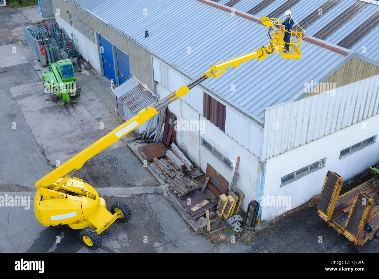 fixing warehouse roof Stock Photo - Alamy