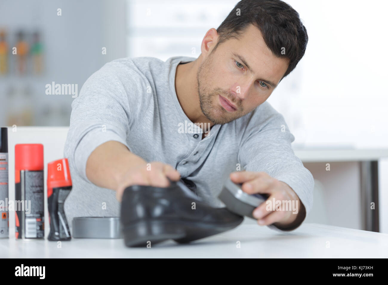 man cleaning his shoe Stock Photo - Alamy