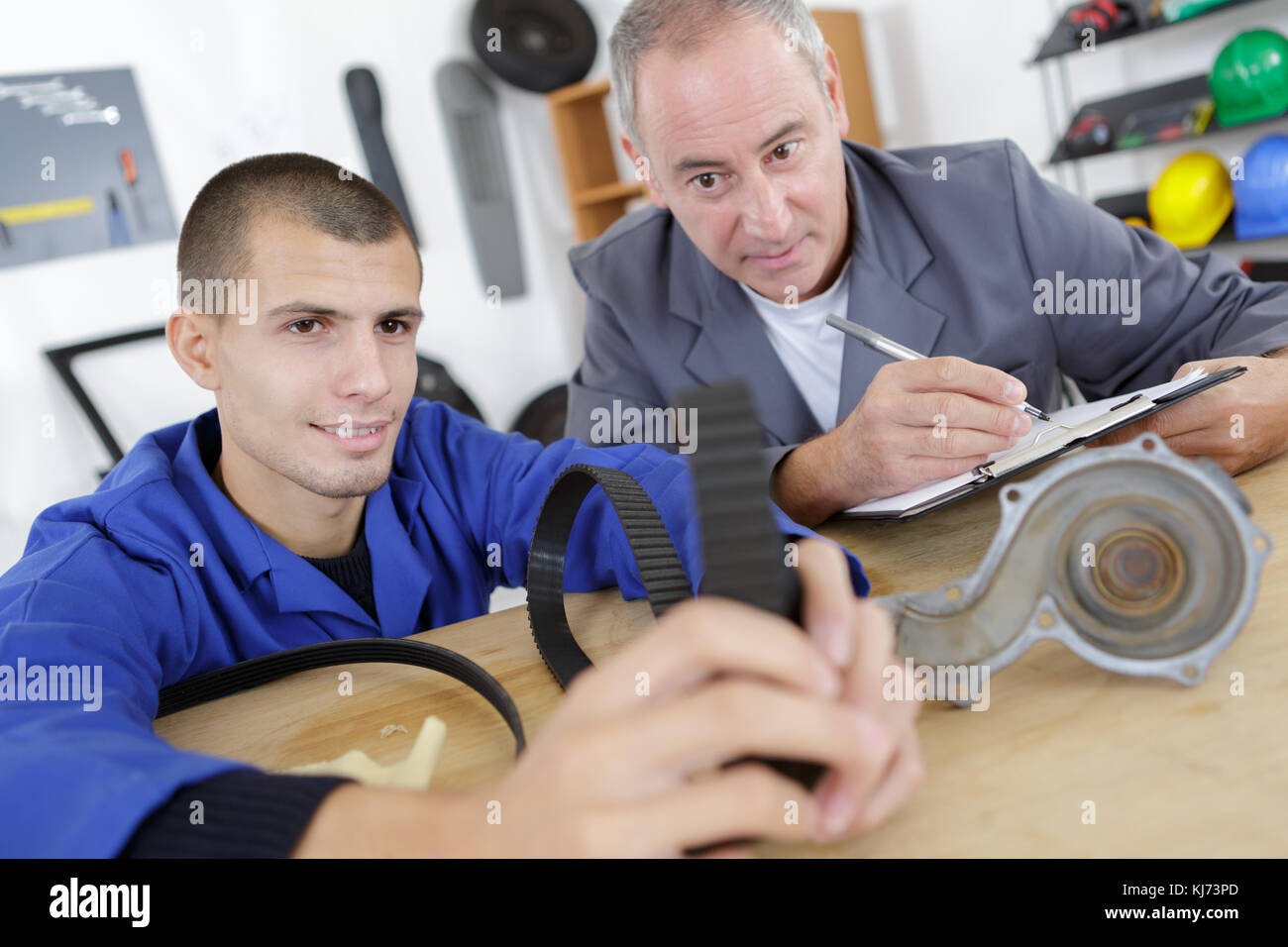 teacher helping student training to be car mechanics Stock Photo - Alamy