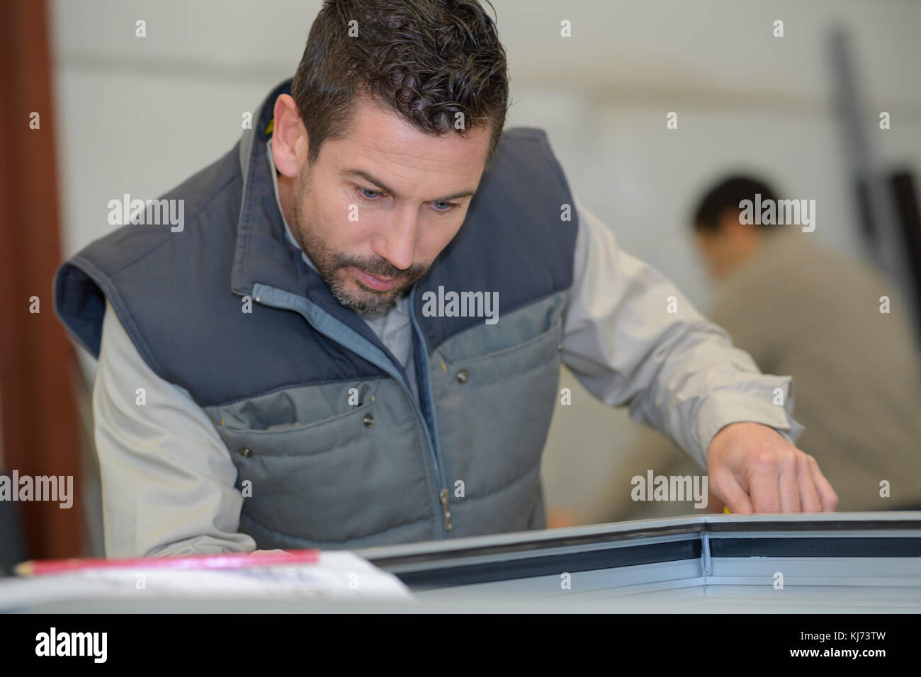 worker with body warmer on Stock Photo - Alamy