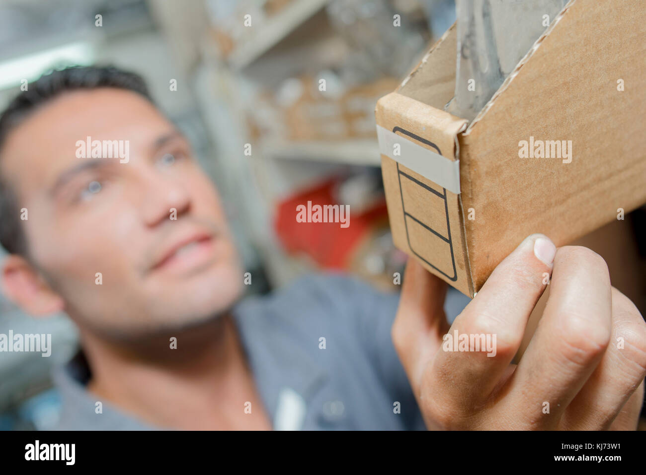 man holding a box Stock Photo - Alamy