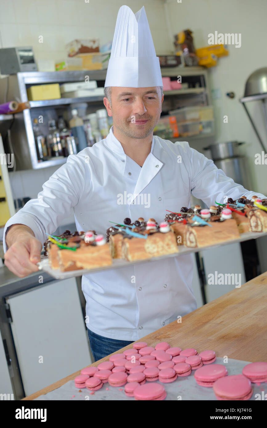 pastry chef holding delicious looking cakes and pastries Stock Photo ...
