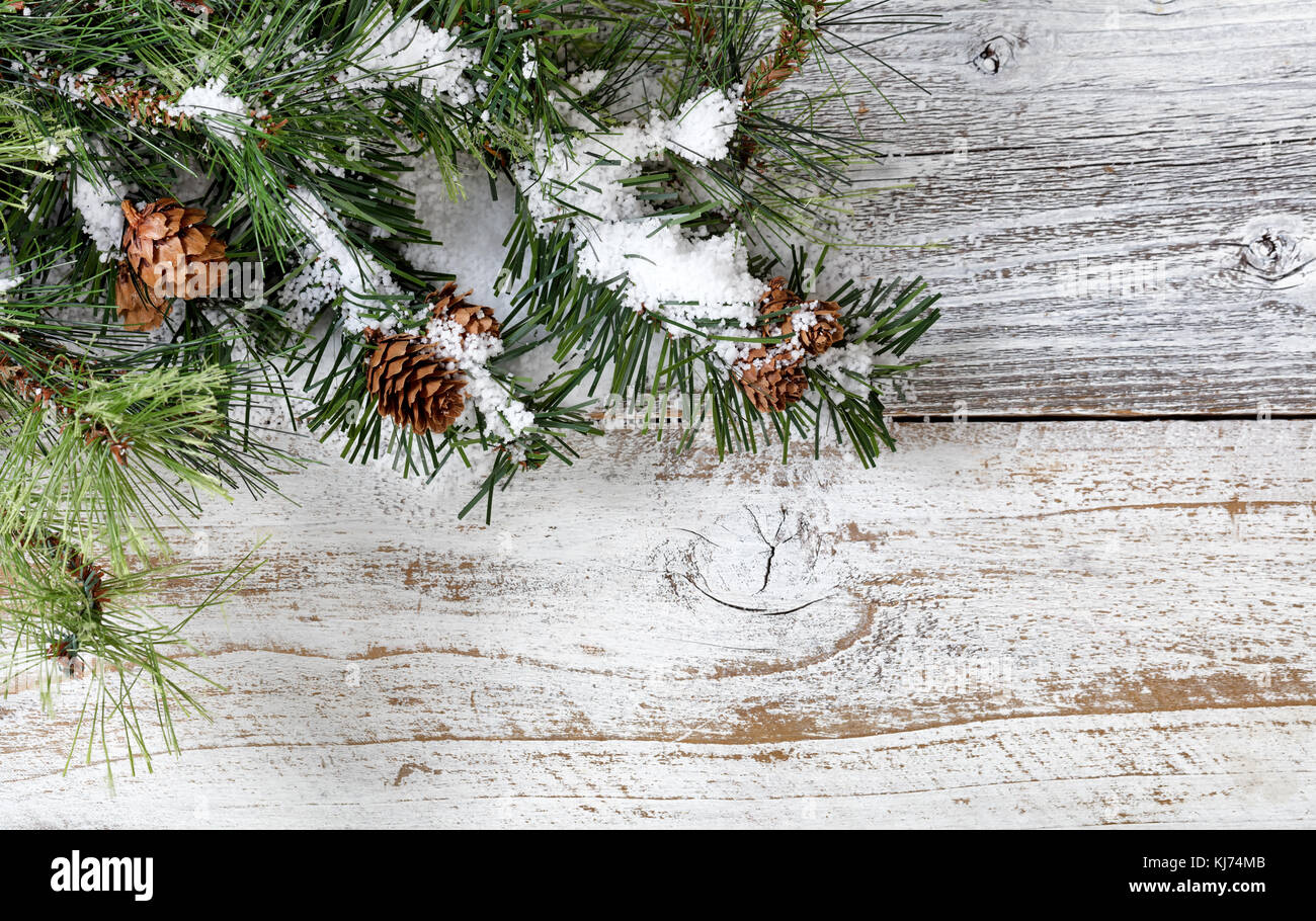 Christmas rough fir tree branches and snow on rustic white wooden ...