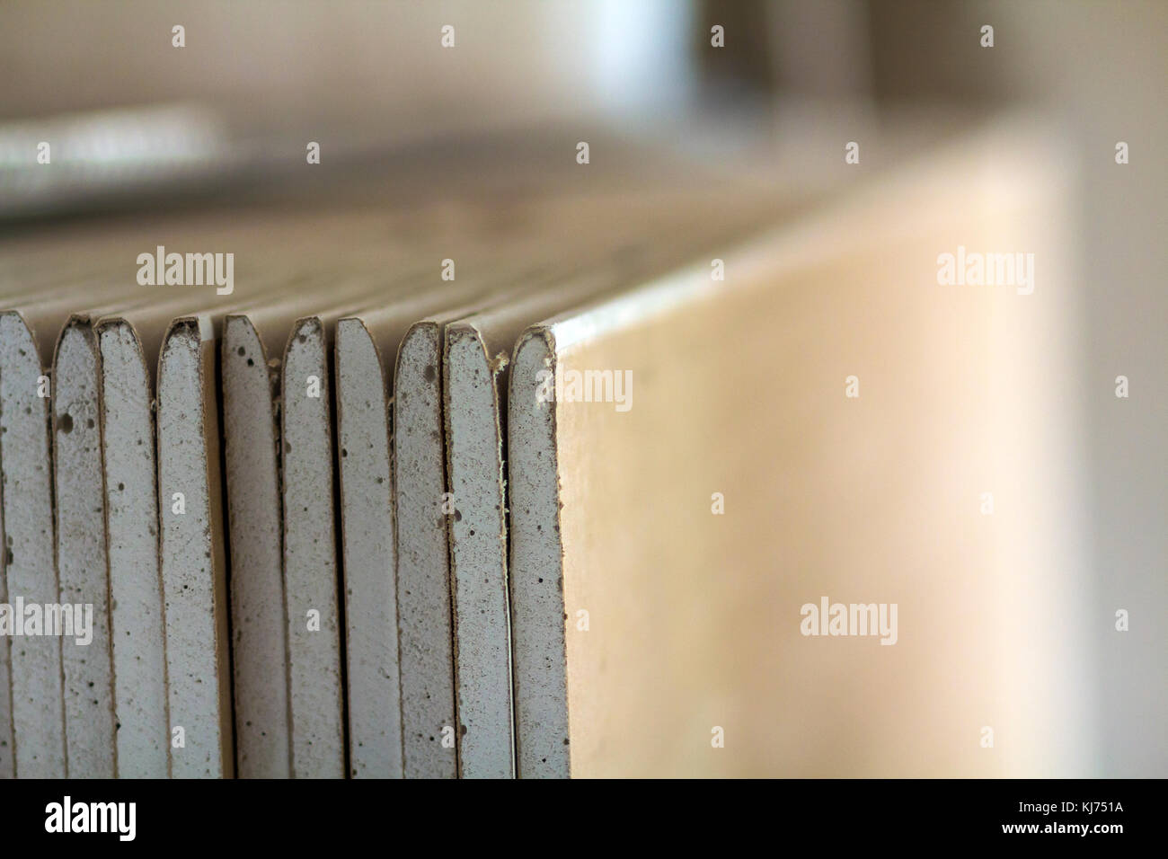 Stack of drywall plates leaning against a wall Stock Photo - Alamy