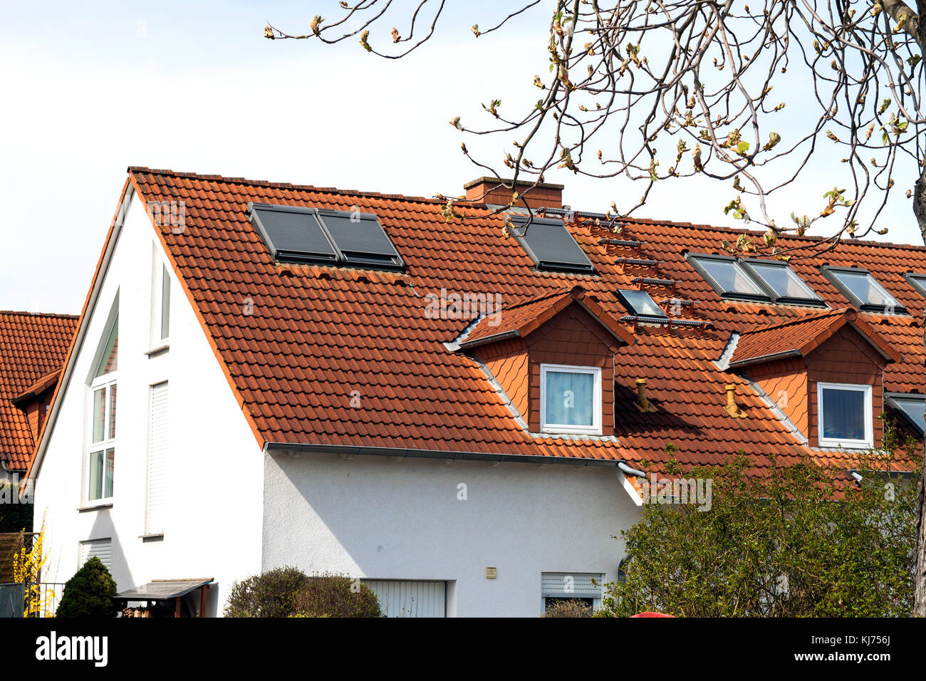 Roof of classic residential houses with orange roofing tiles and ...